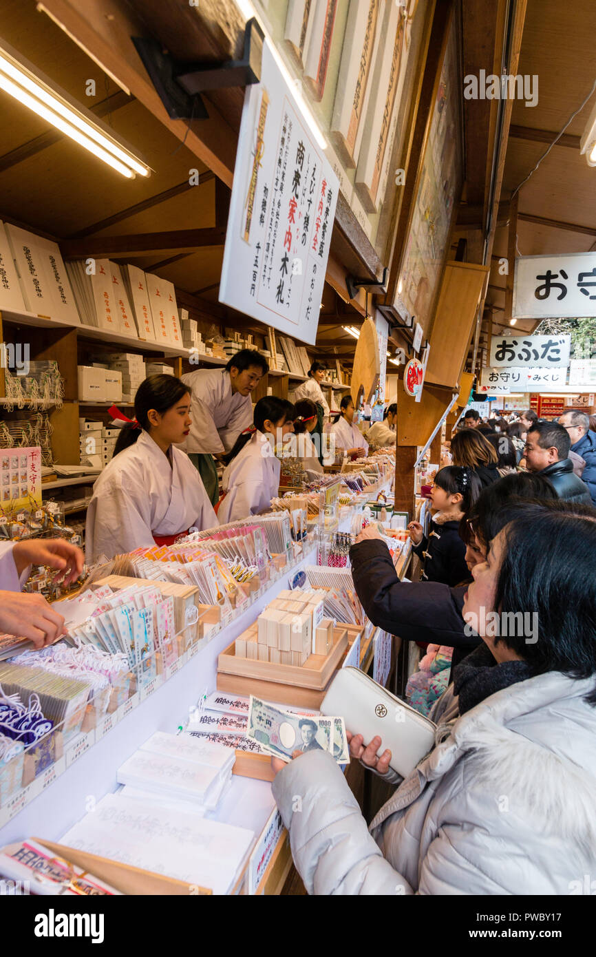 Japanese new year, shogatsu. People at busy counter of shrine office ...