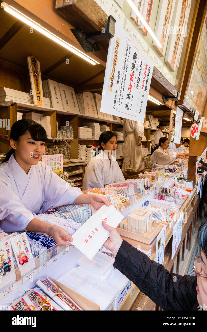 Japanese new year, shogatsu. People at busy counter of shrine office ...