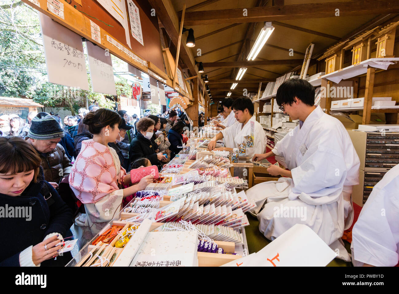 Japanese new year, shogatsu. People at busy counter of shrine office ...