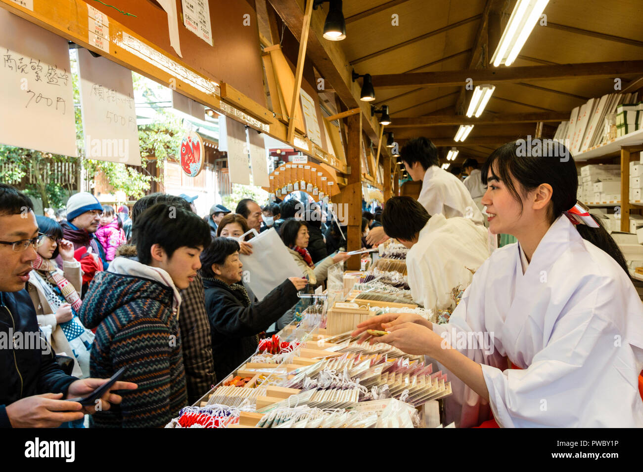 Japanese new year, shogatsu. People at busy counter of shrine office ...