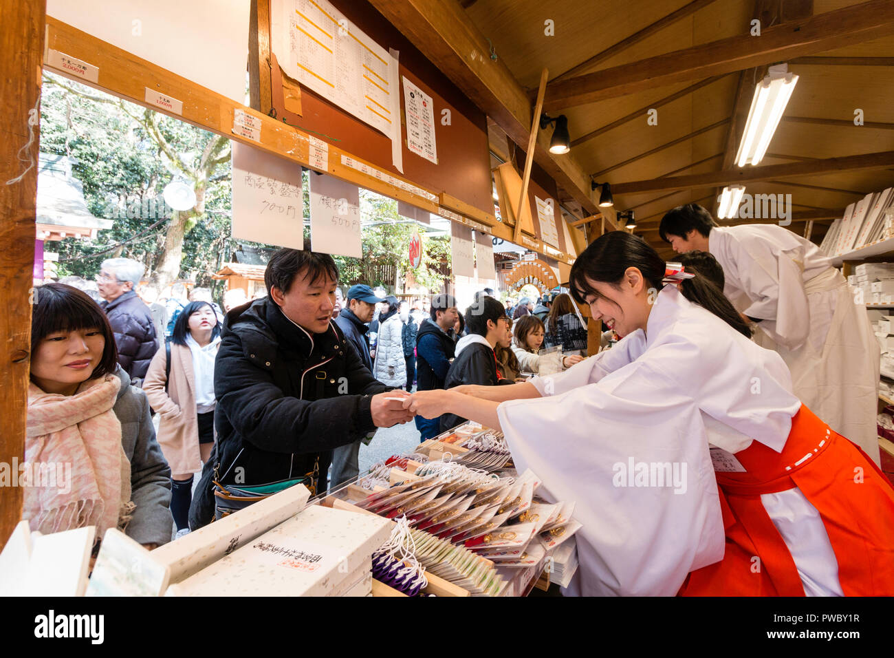 Japanese new year, shogatsu. People at busy counter of shrine office ...