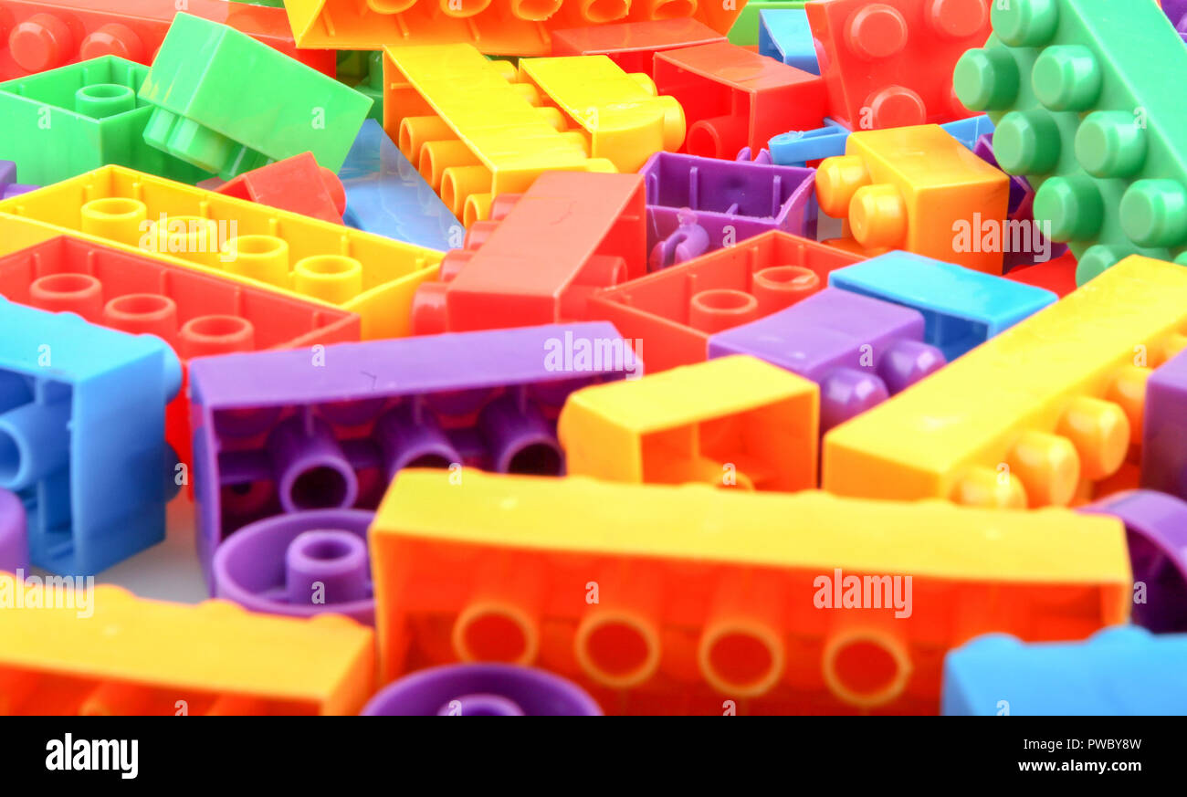 Plastic colorful toy blocks on white background Stock Photo - Alamy