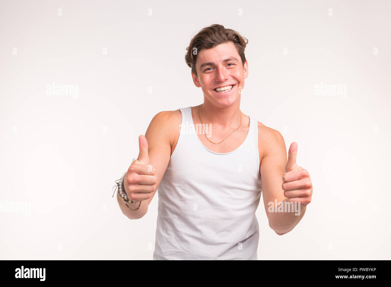 Optimism, humor, people concept - happy man showing thumbs up, because ...