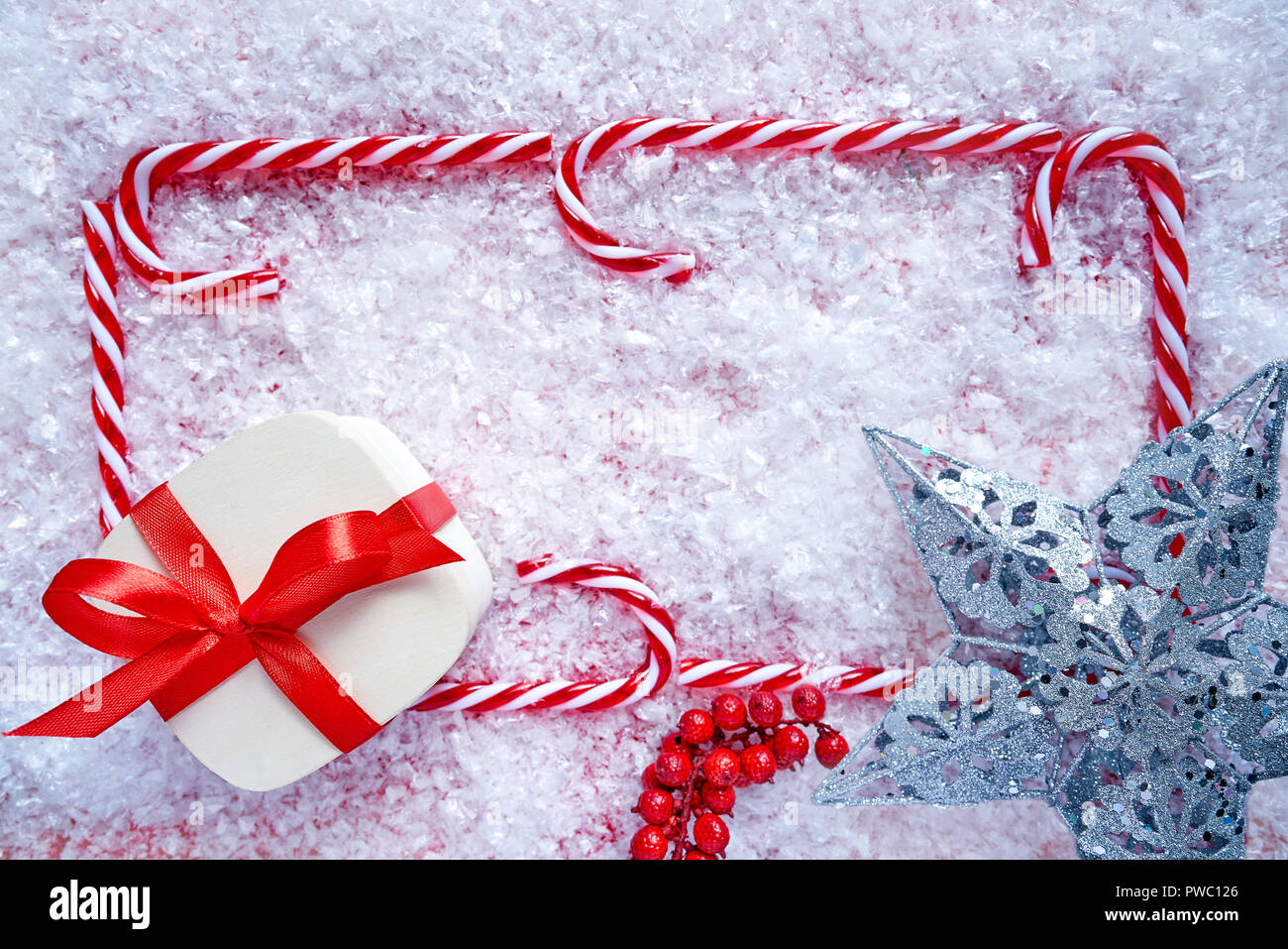 Christmas gift and candy cane frame on snow background border Stock ...