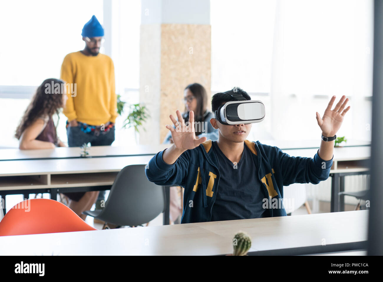 Content handsome young Asian male app developer in casual clothing ...