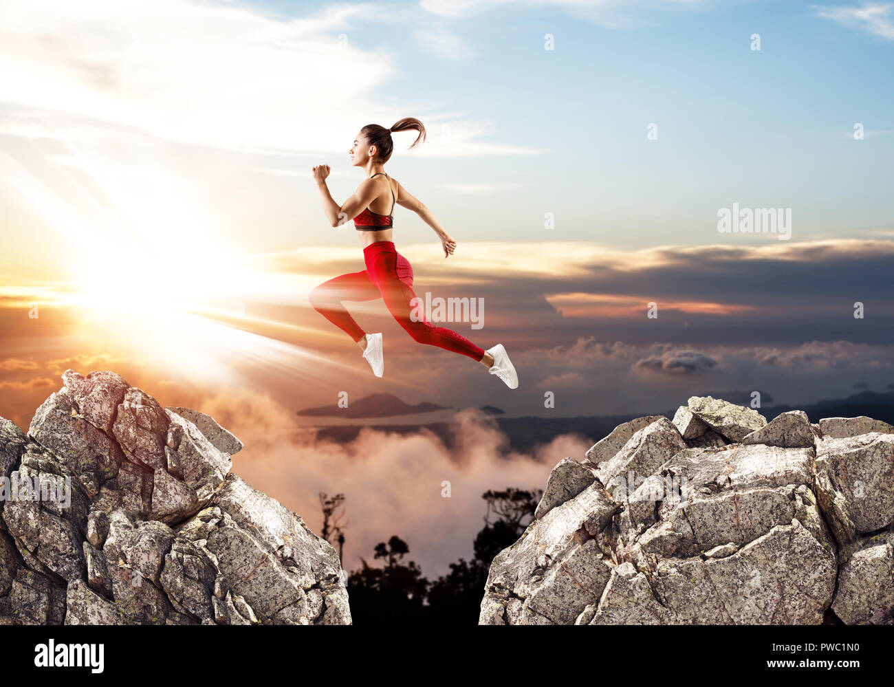 Woman jump through the gap between hills over sunset background Stock ...
