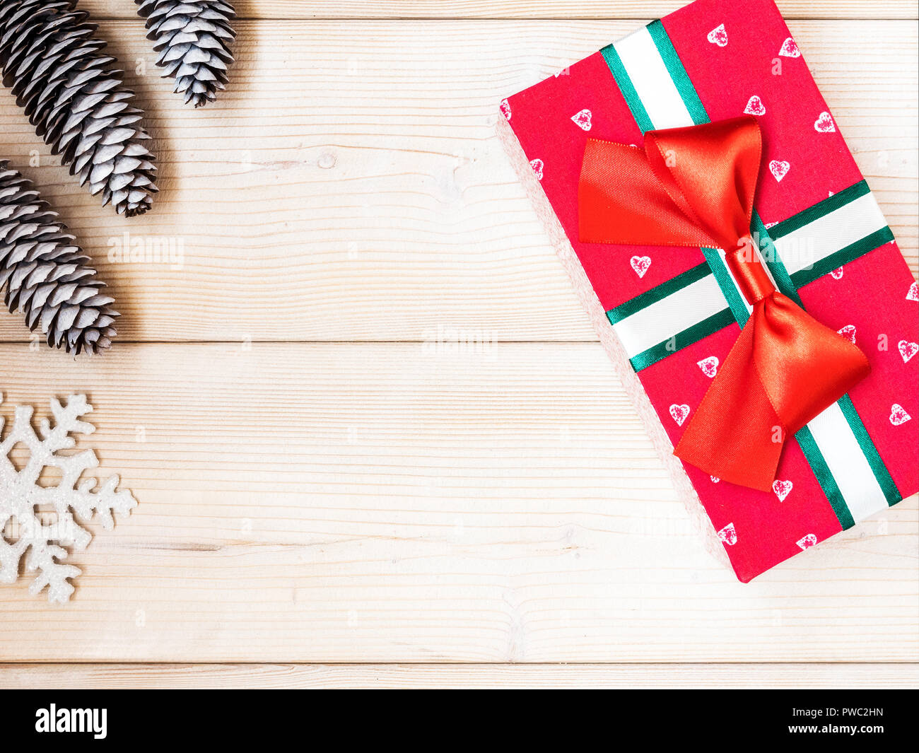 Christmas theme with fir cones along with gift box on the wooden ...