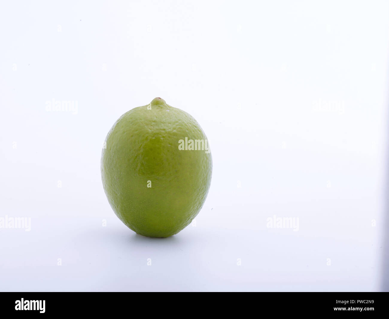 Lime food still-life on plain background Stock Photo - Alamy