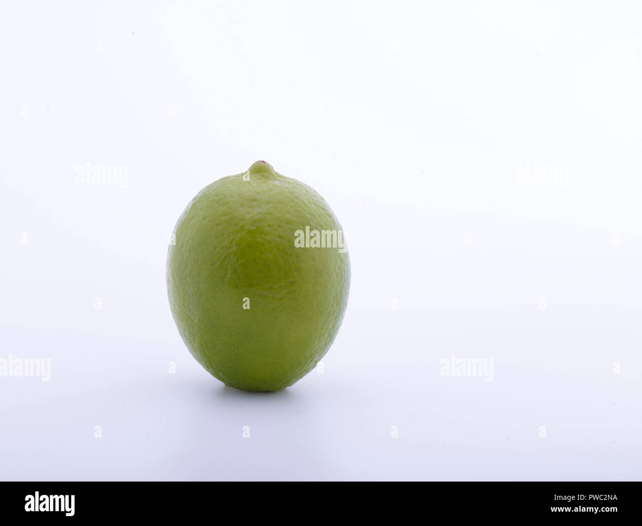 Lime food still-life on plain background Stock Photo - Alamy