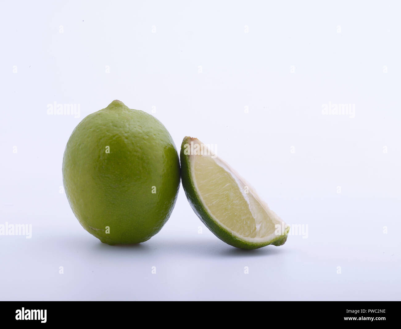 Lime food still-life on plain background Stock Photo - Alamy