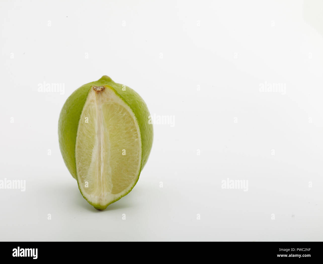 Lime food still-life on plain background Stock Photo - Alamy