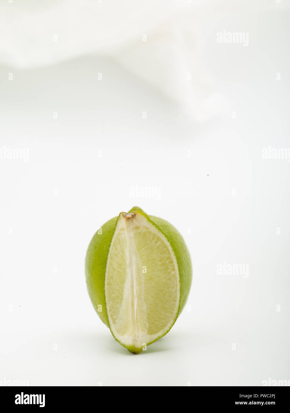 Lime food still-life on plain background Stock Photo - Alamy