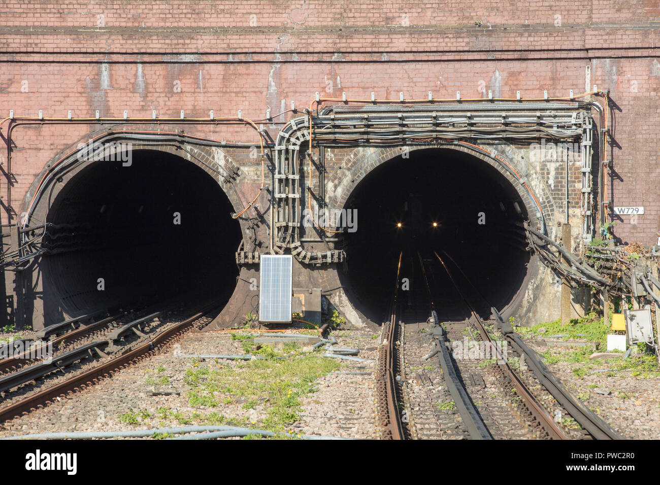 London underground tube train emerging from a tunnel on the northern ...
