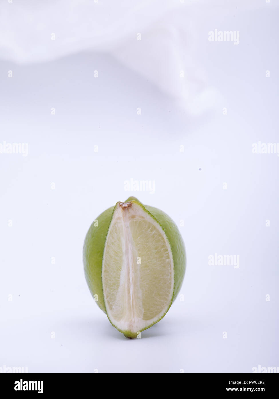 Lime food still-life on plain background Stock Photo - Alamy