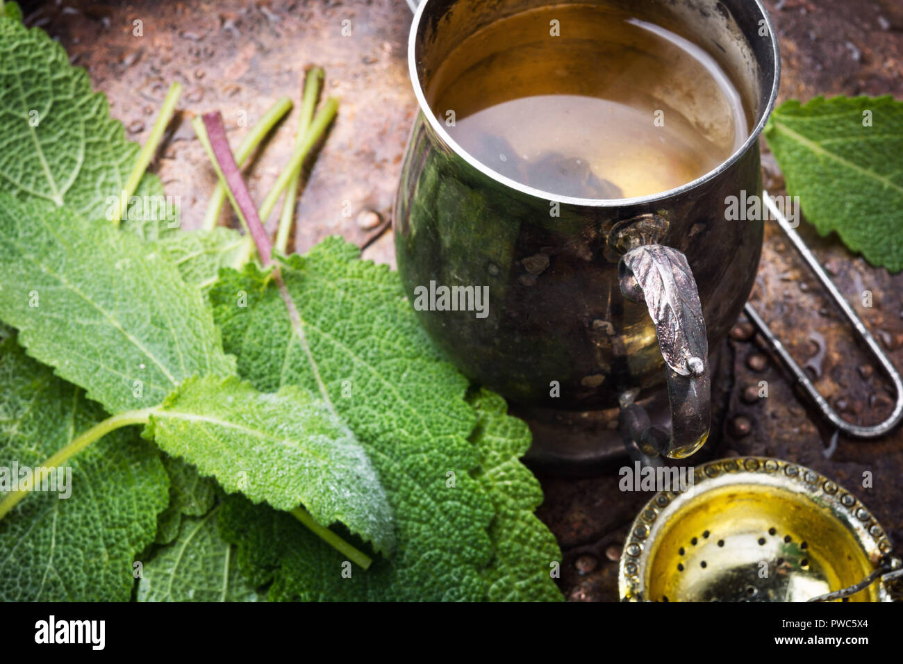 Brewed delicious herbal tea with sage on retro background Stock Photo ...