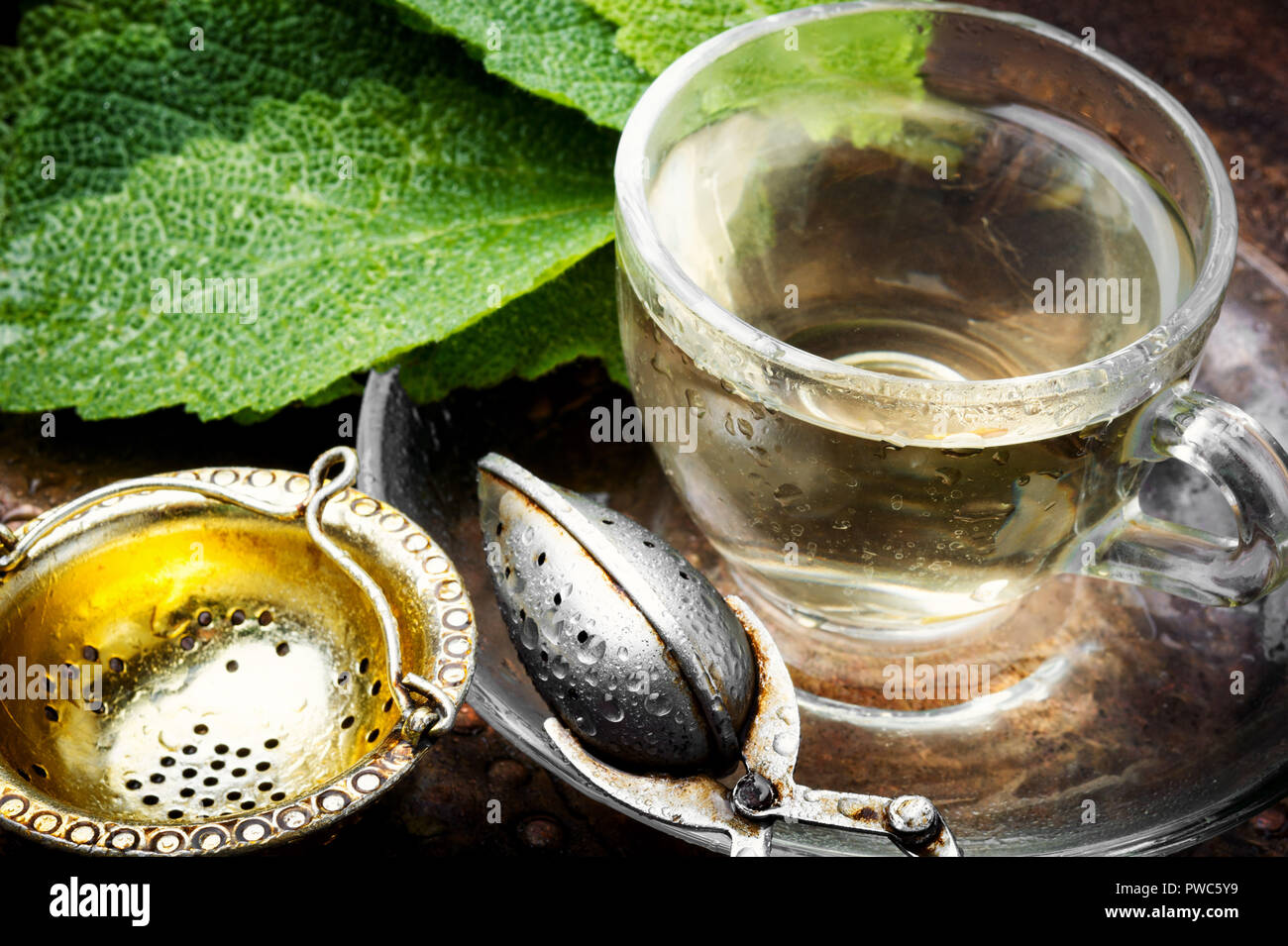 Brewed delicious herbal tea with sage on retro background.Herbal tea ...