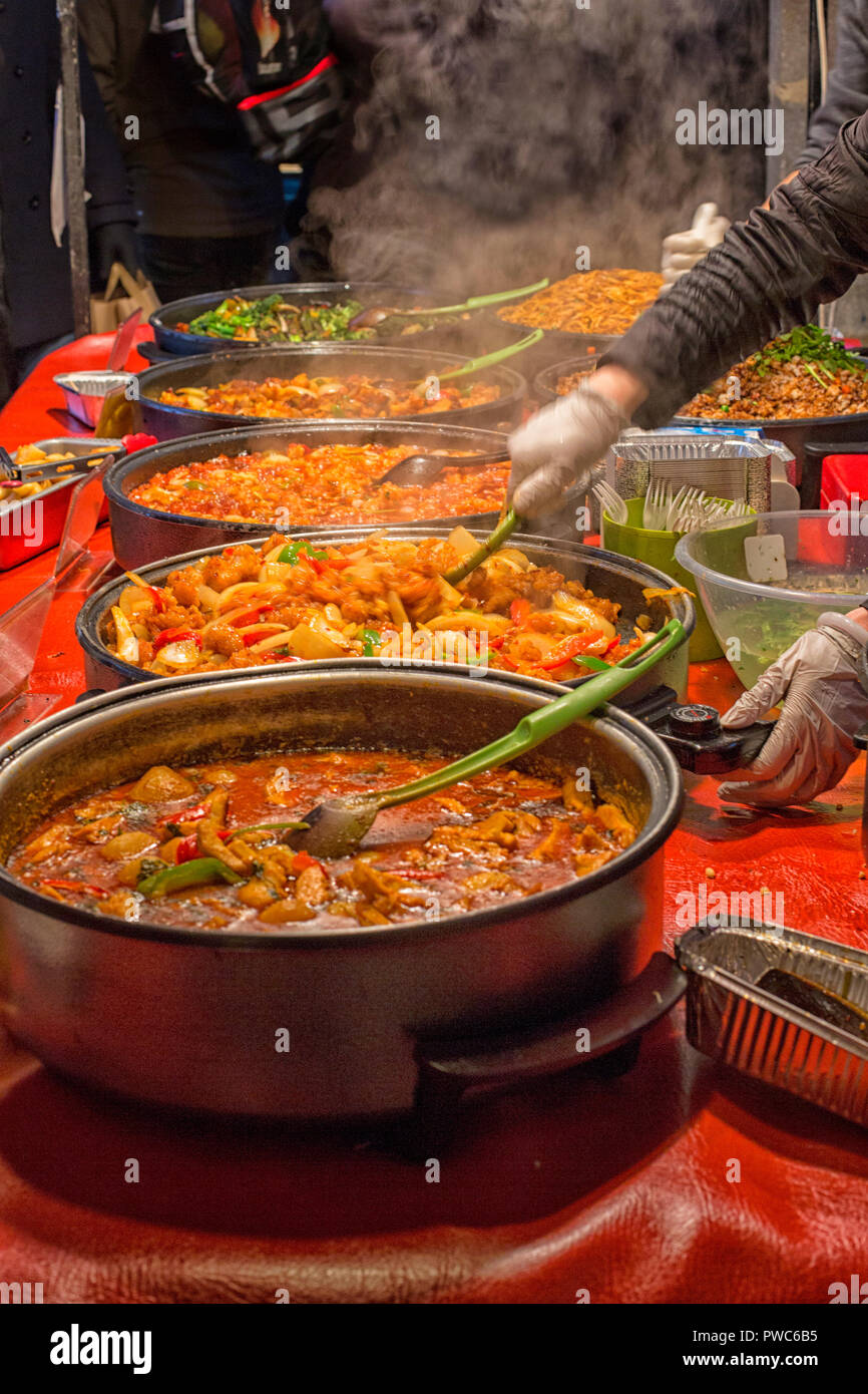 Malaysian food cooking and steaming in their pots at a market stall ...