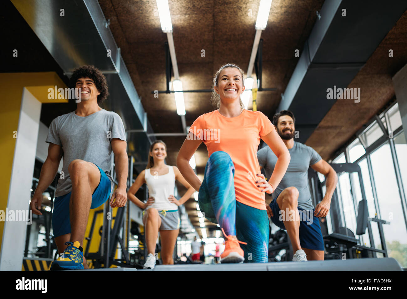 Group of young people doing exercises in gym Stock Photo - Alamy