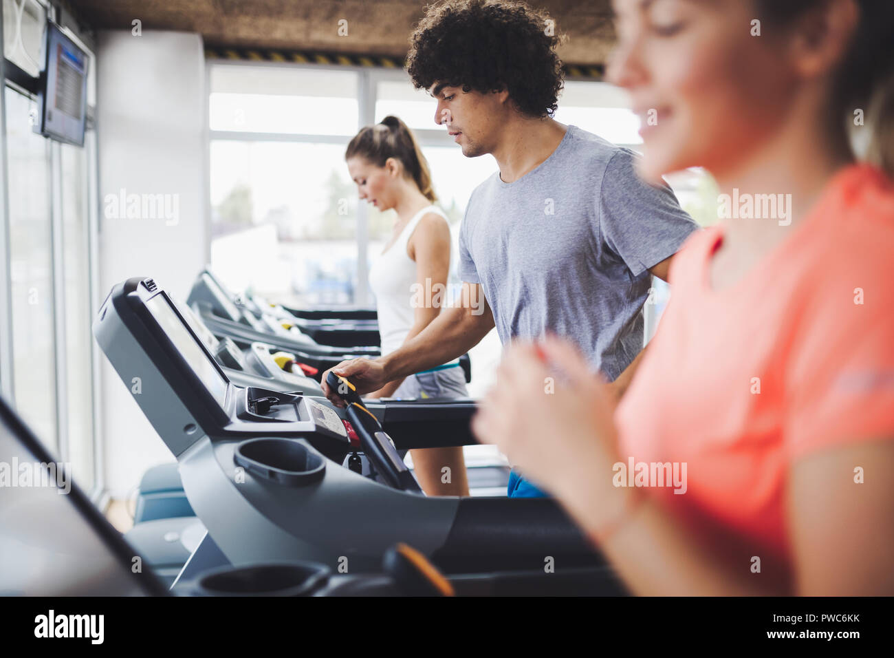 Picture of people running on treadmill in gym Stock Photo - Alamy