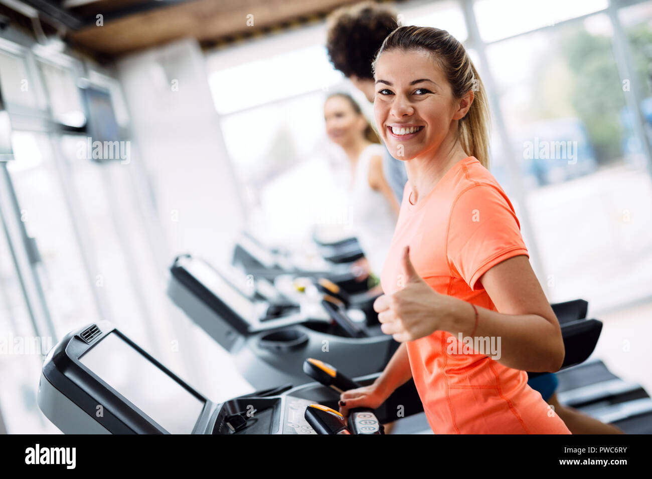 Picture of people running on treadmill in gym Stock Photo - Alamy
