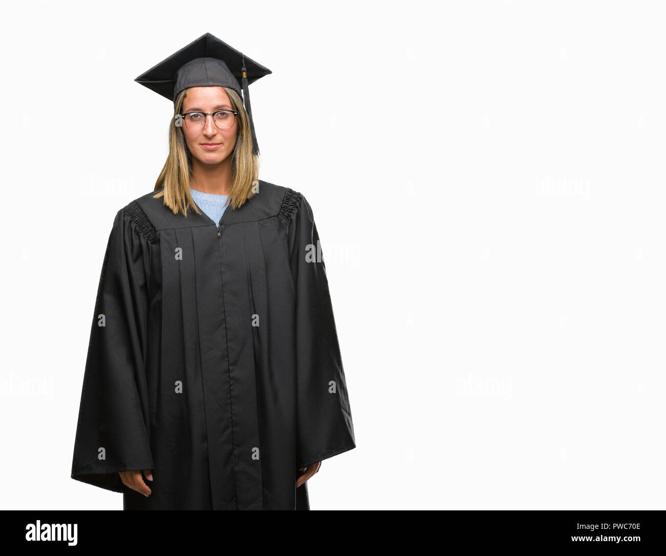 Young beautiful woman wearing graduated uniform over isolated ...