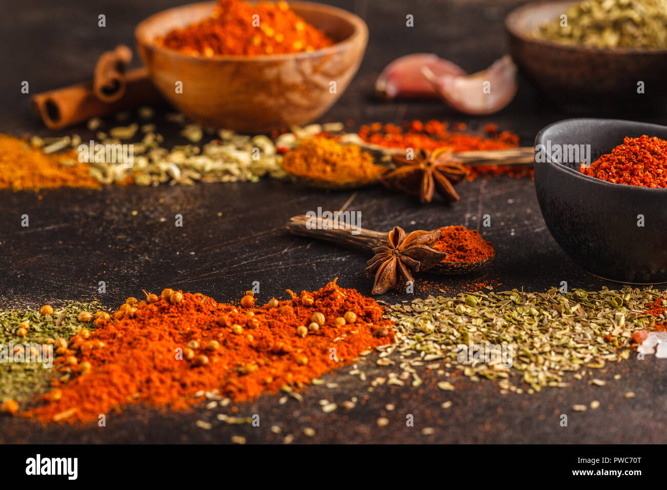 Different kind of spices in wooden bowls on dark background. Food ...