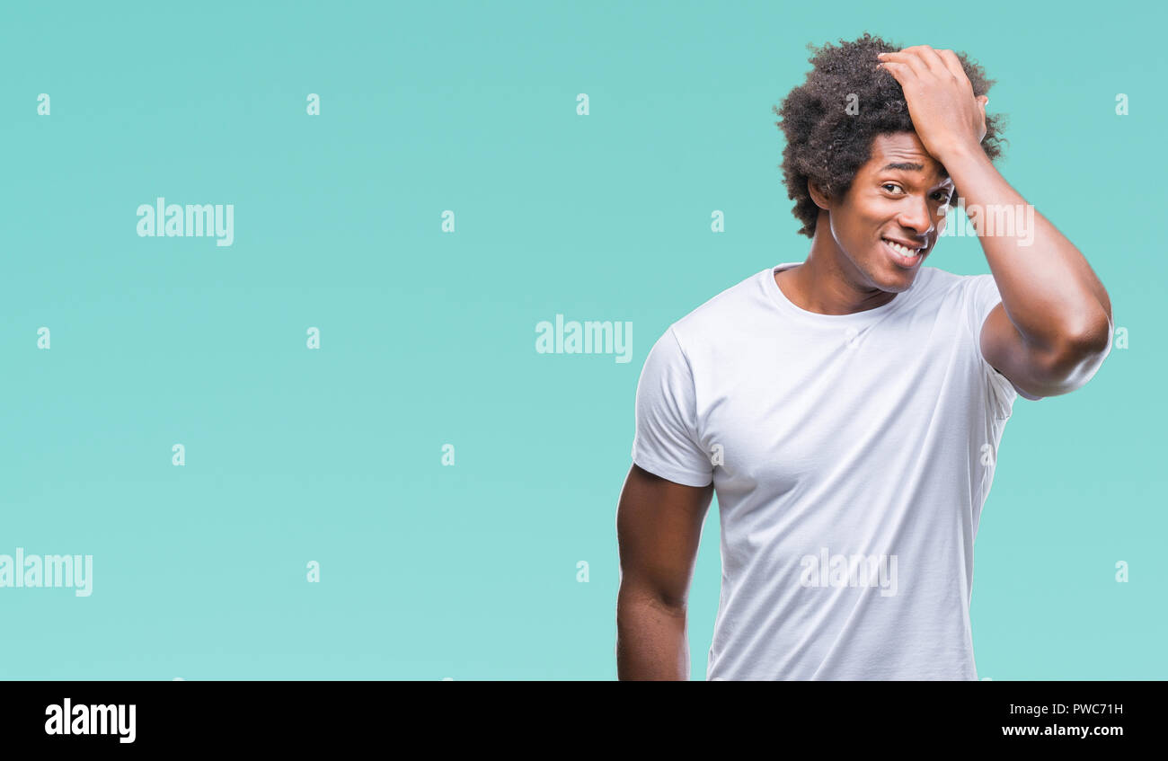 Afro american man over isolated background surprised with hand on head ...