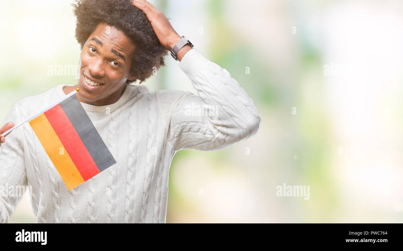 Afro american man flag of Germany over isolated background stressed ...