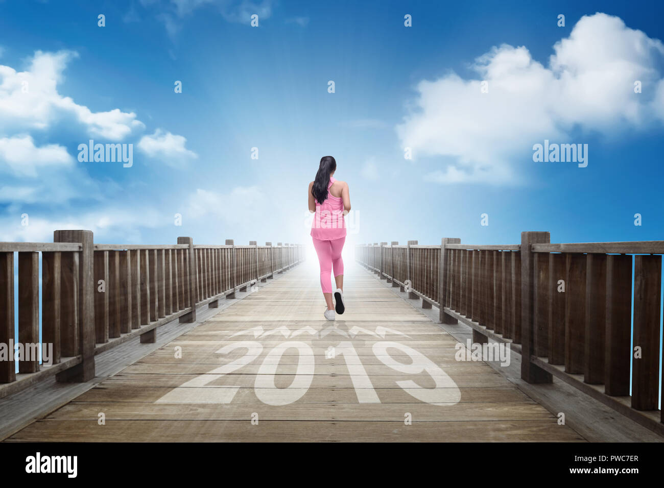 Rear view of woman running into new year of 2019. Happy New Year 2019 ...