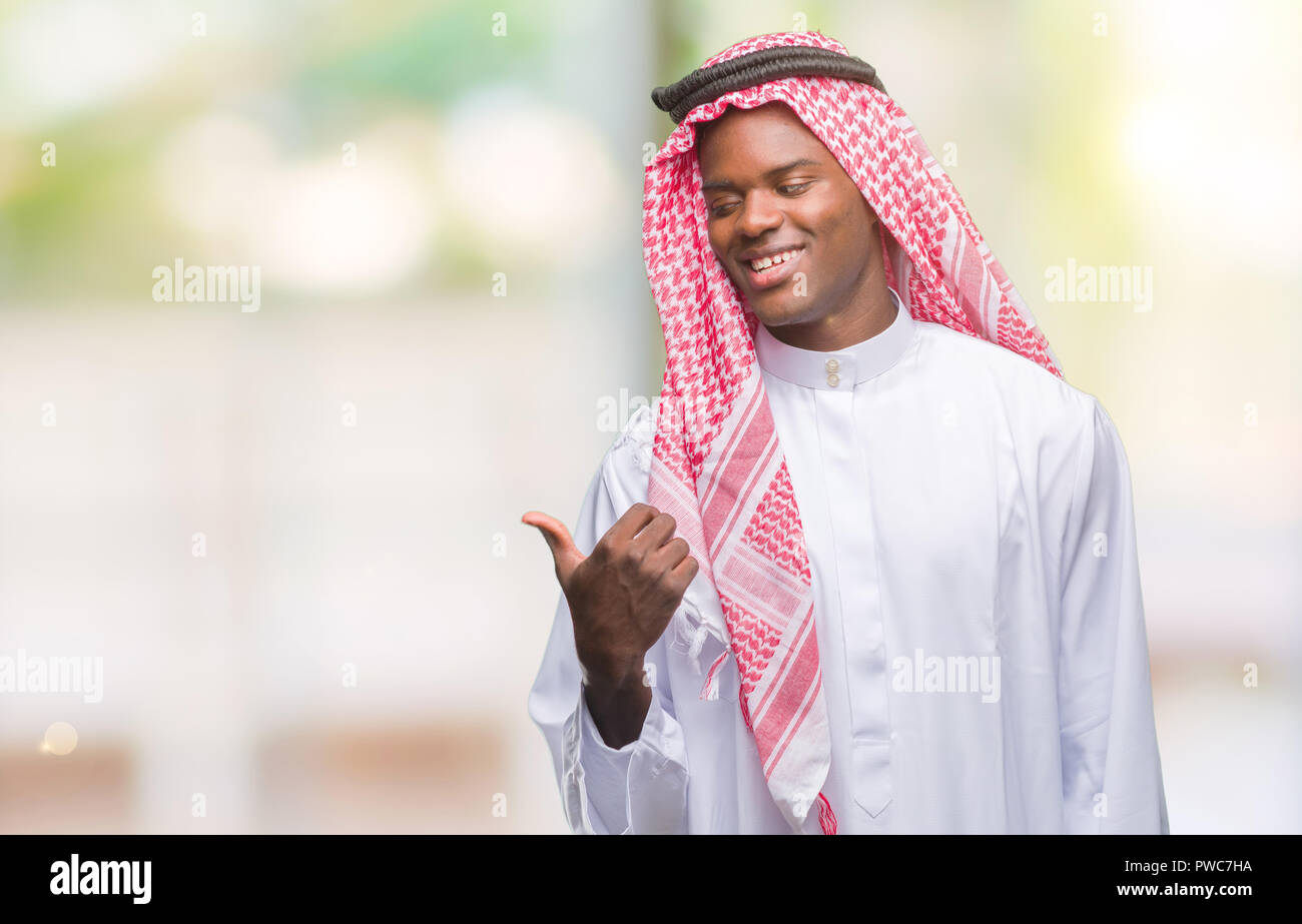 Young arabic african man wearing traditional keffiyeh over isolated ...