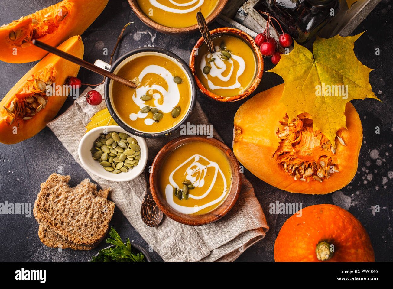 Autumn pumpkin soup puree with cream in cups, the autumn scenery ...