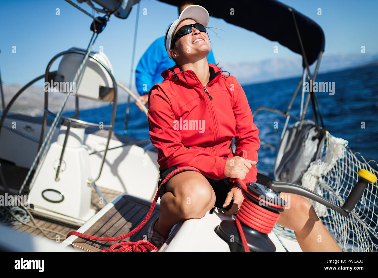 Attractive strong woman sailing with her boat Stock Photo - Alamy