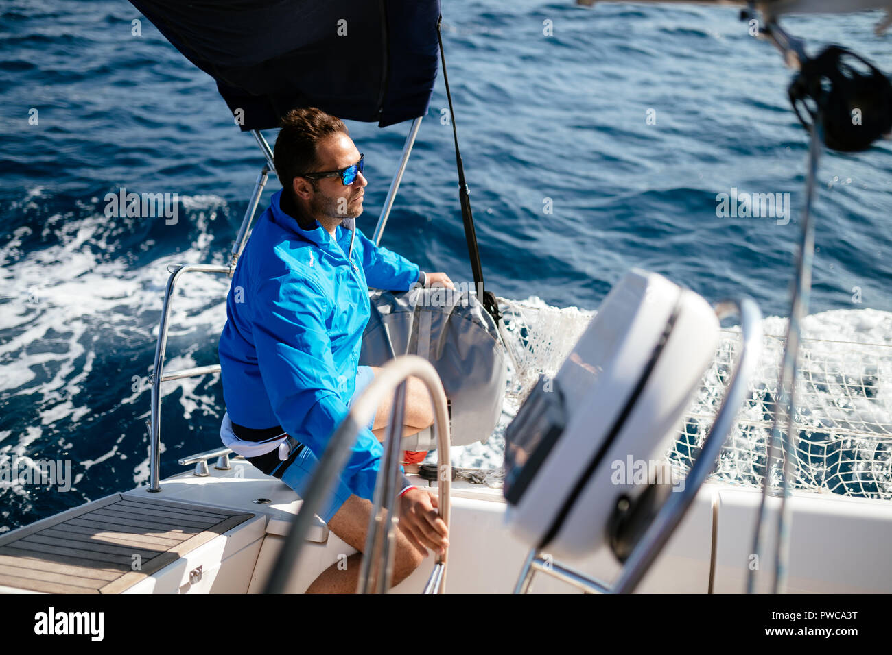 Handsome strong man sailing with his boat Stock Photo - Alamy