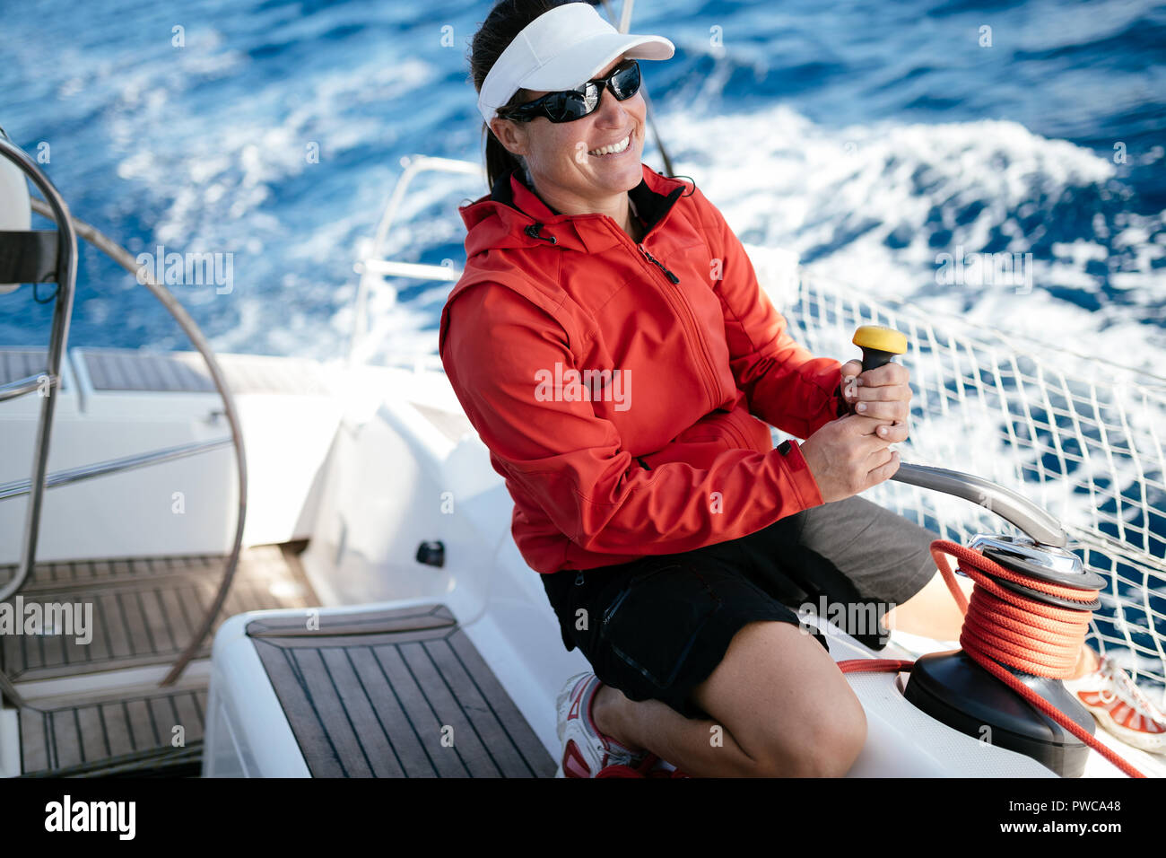 Attractive strong woman sailing with her boat Stock Photo - Alamy