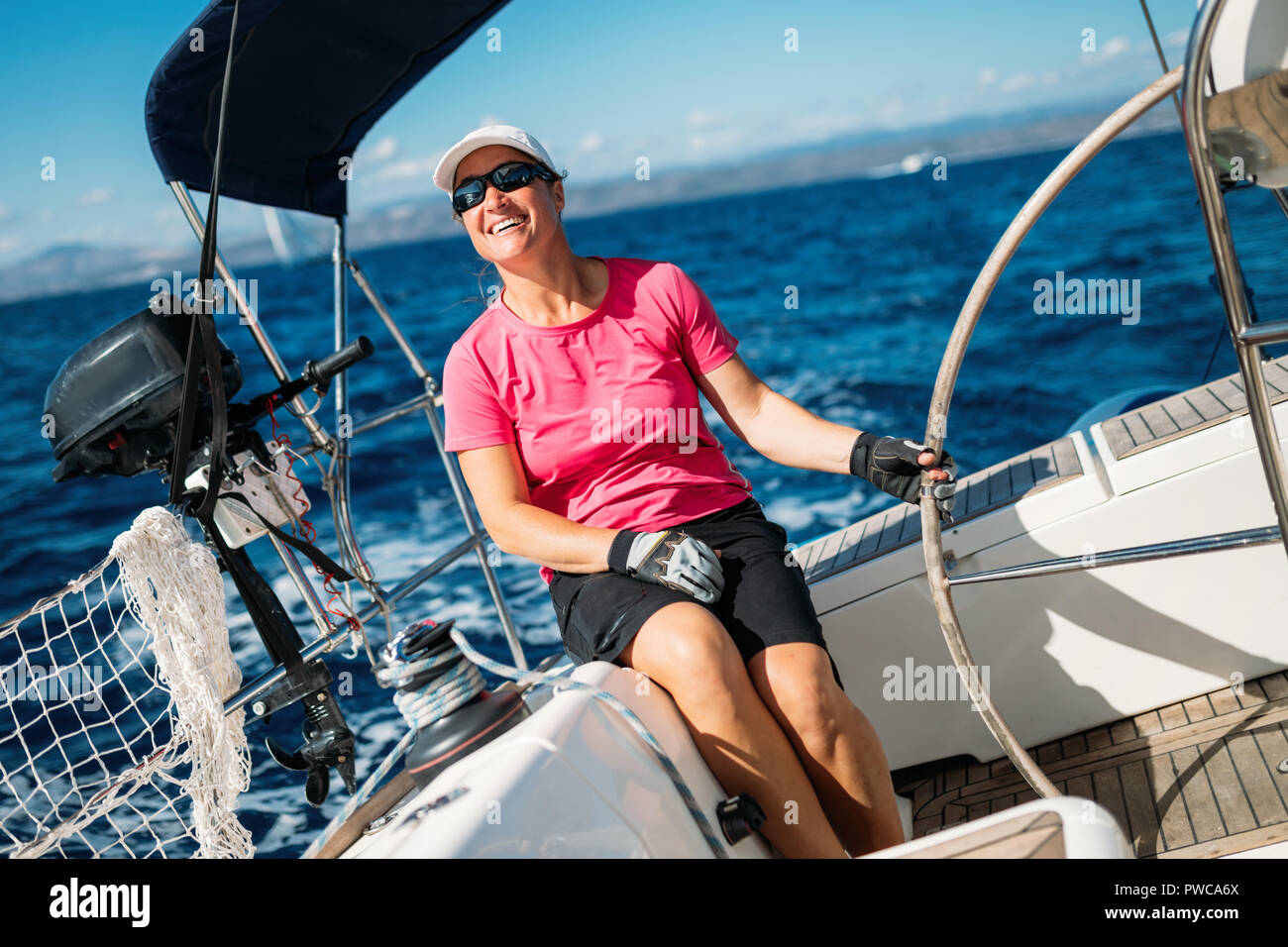 Happy strong woman sailing with her boat Stock Photo - Alamy