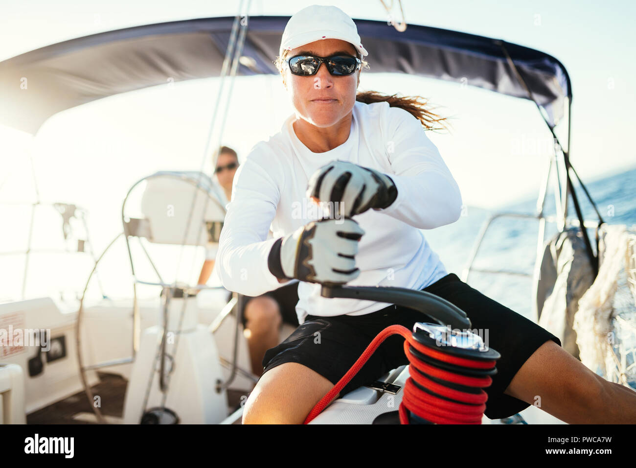 Attractive strong woman sailing with her boat Stock Photo - Alamy