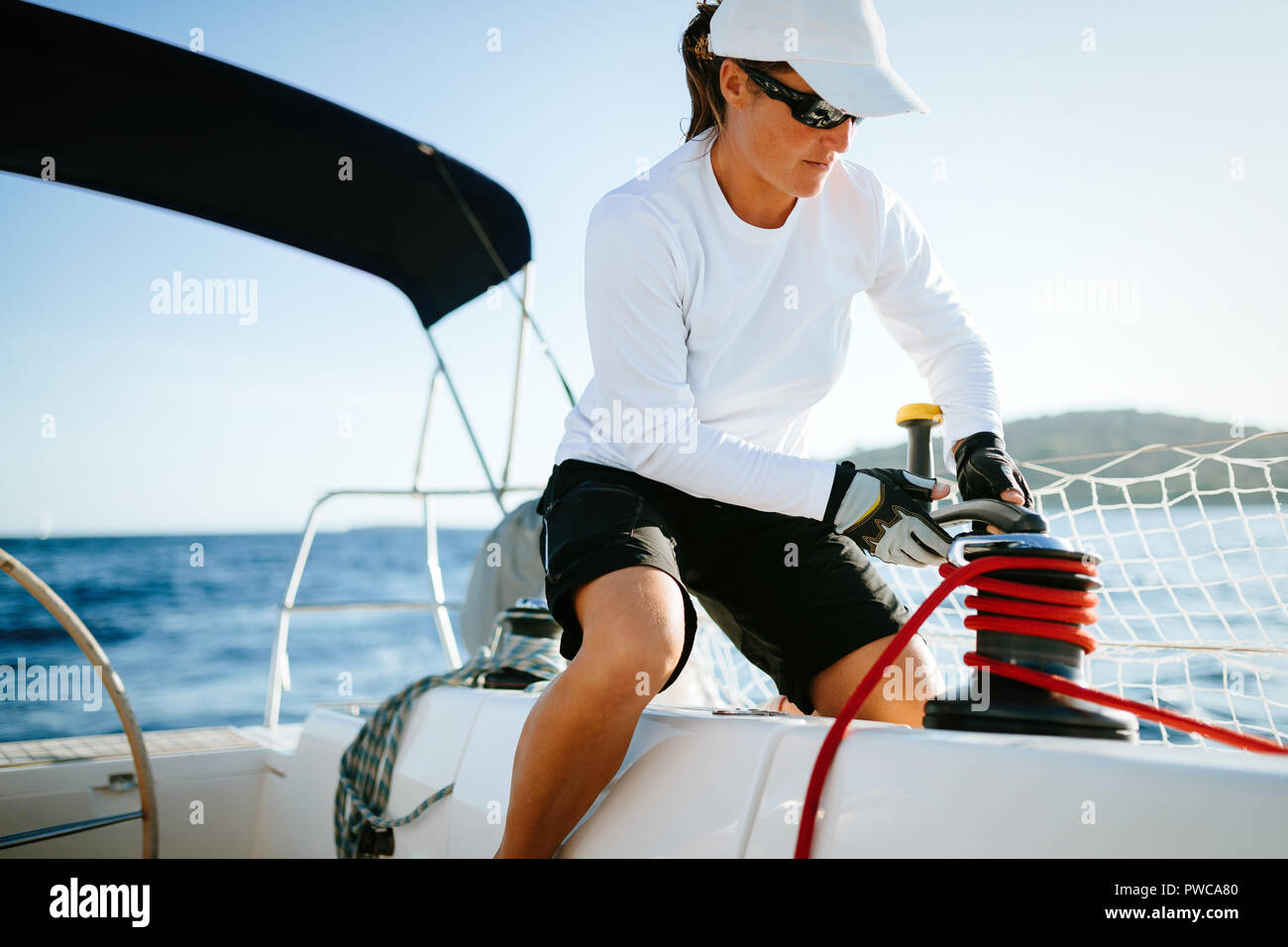Attractive strong woman sailing with her boat Stock Photo - Alamy