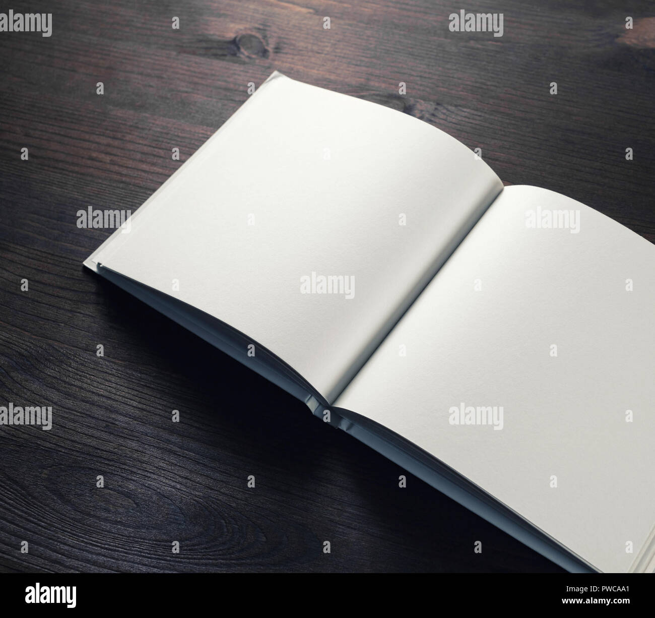 Blank opened book on wooden background. Template for graphic designers ...