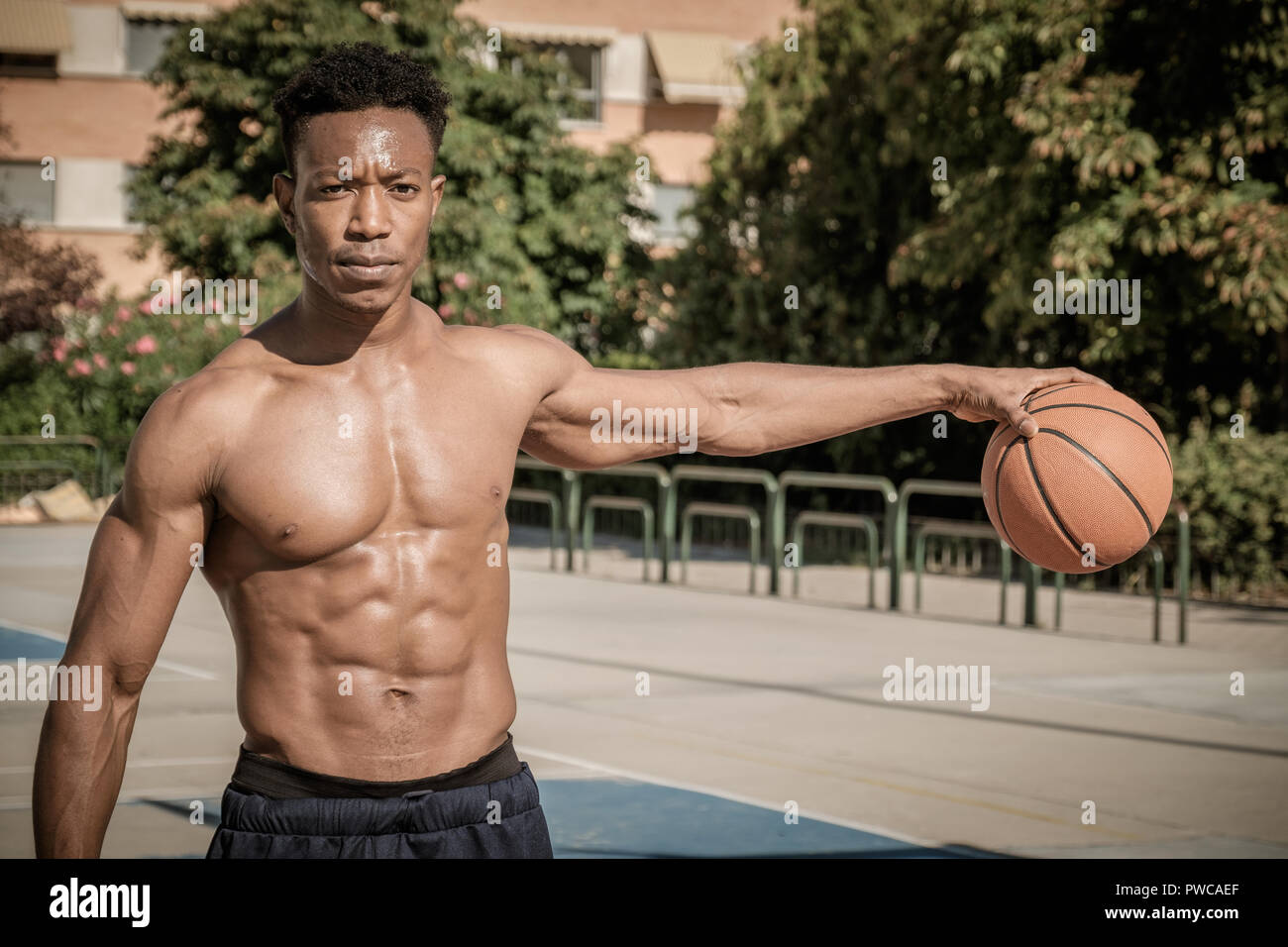 Young man holding basketball court hi-res stock photography and images ...