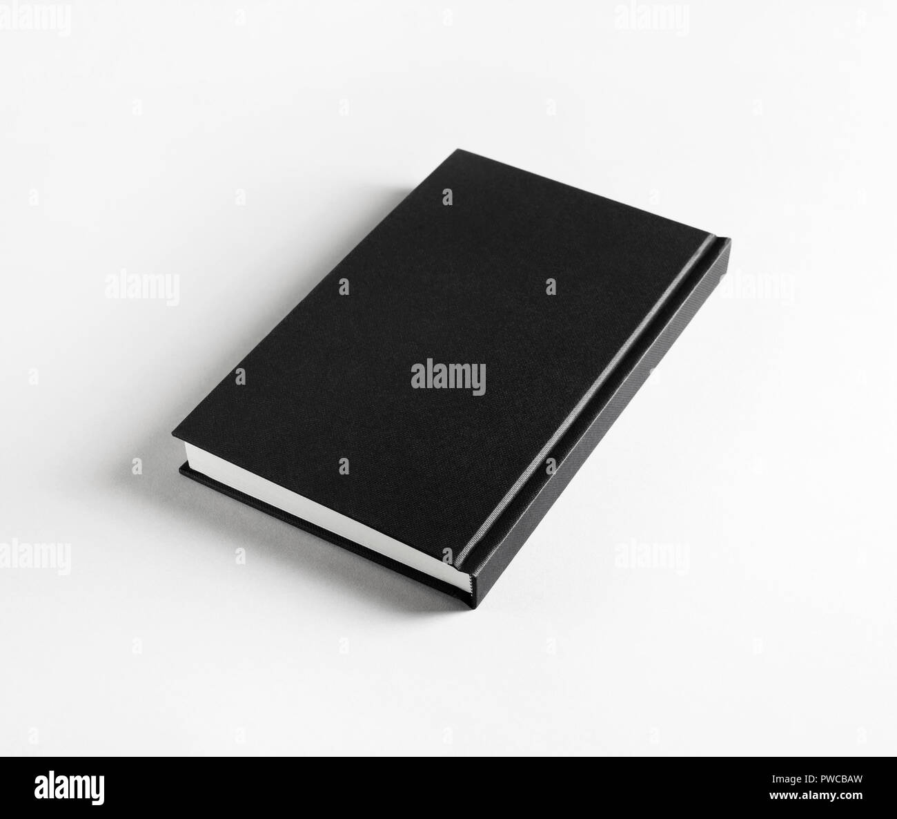Closed blank black book at white paper background. Responsive design ...