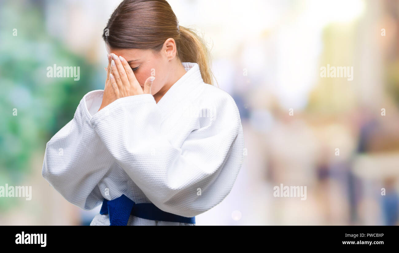Young beautiful woman wearing karate kimono uniform over isolated ...