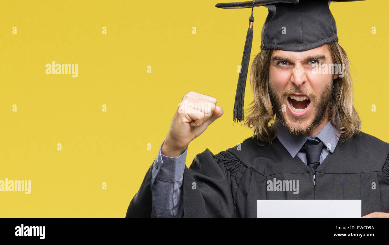 Young handsome graduate man with long hair holding blank paper over ...