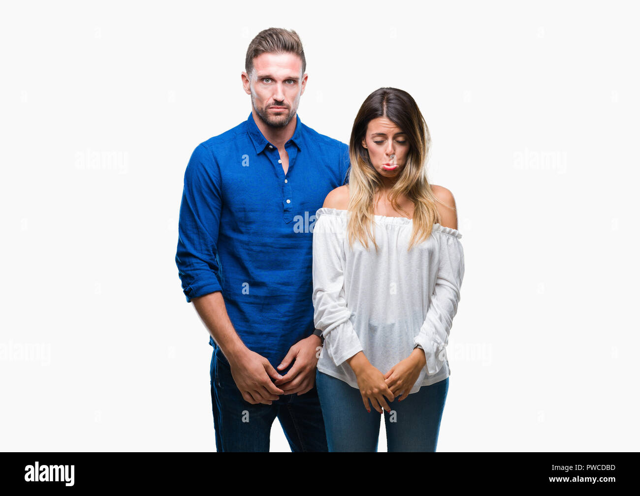 Young couple in love over isolated background depressed and worry for ...