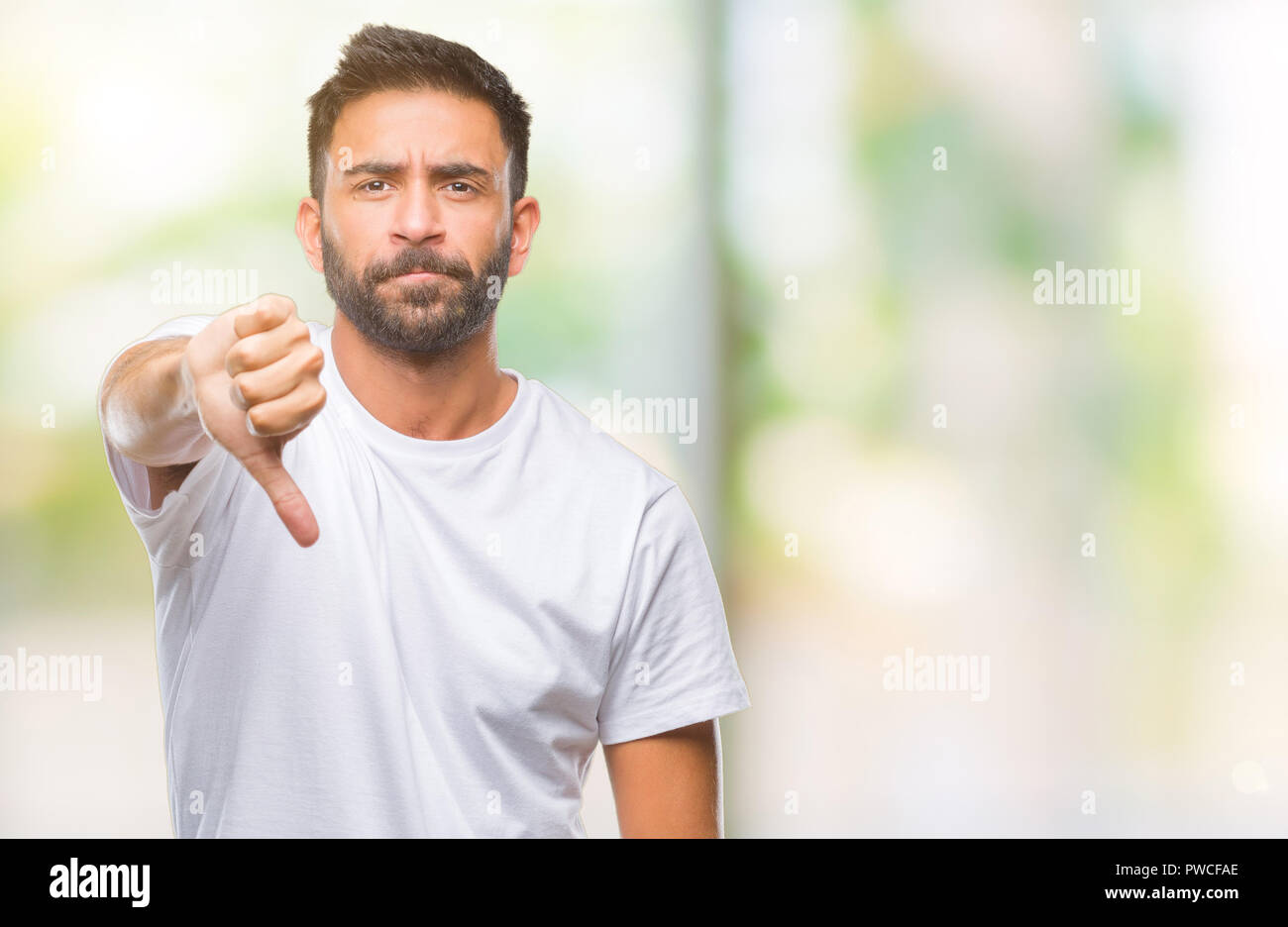 Adult hispanic man over isolated background looking unhappy and angry ...