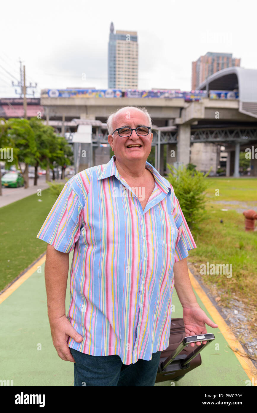 Overweight senior tourist man exploring around the city of Bangk Stock ...