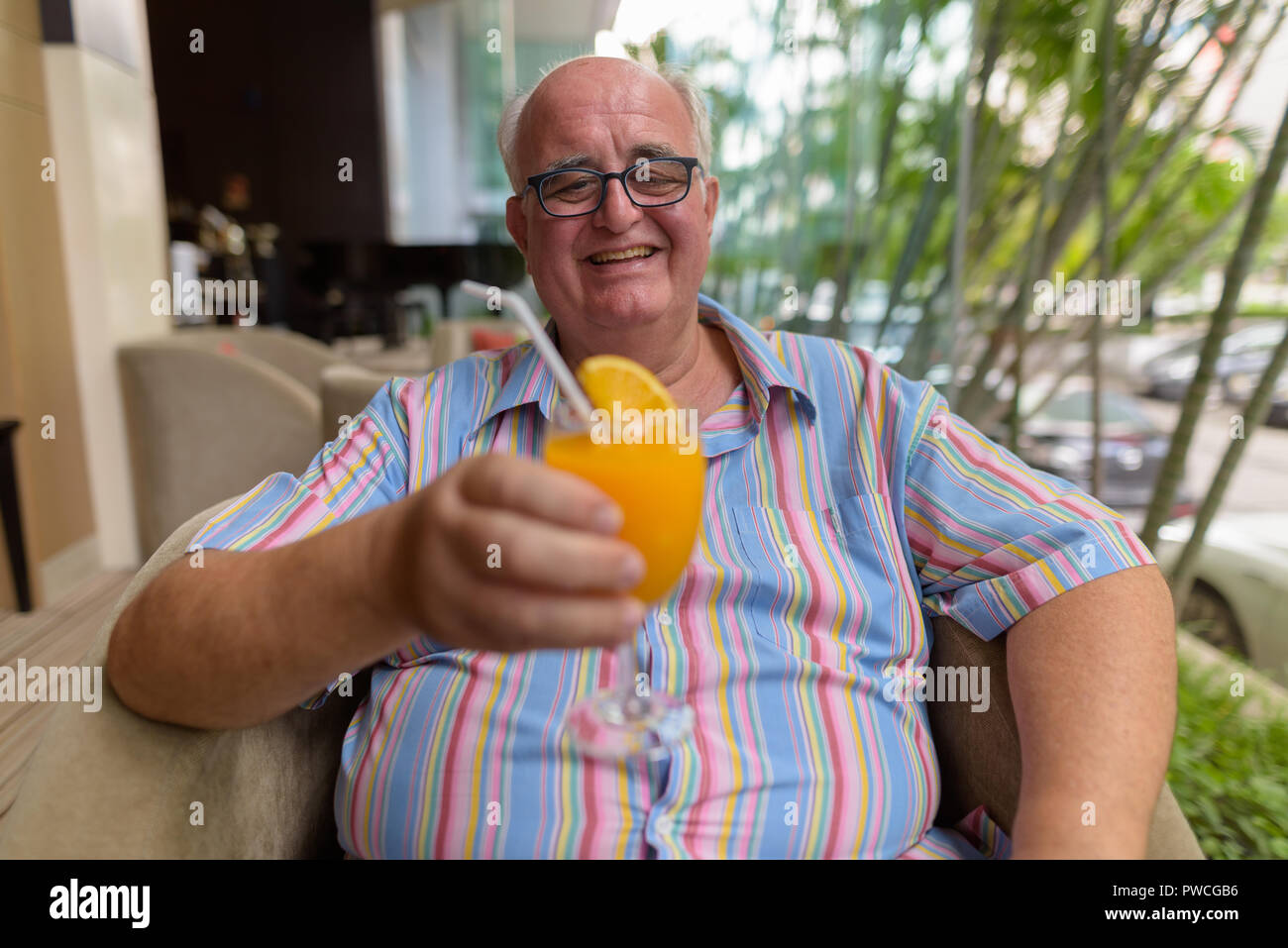 Overweight senior tourist man exploring around the city of Bangk Stock ...