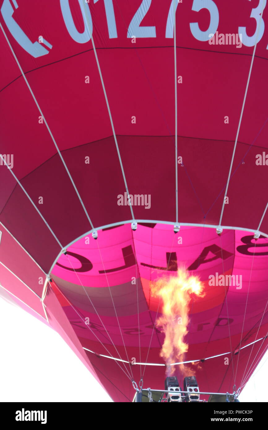 A red hot air balloon taking off Stock Photo - Alamy