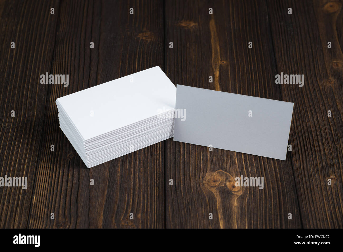 Blank business cards on wooden working table with copy space for add ...