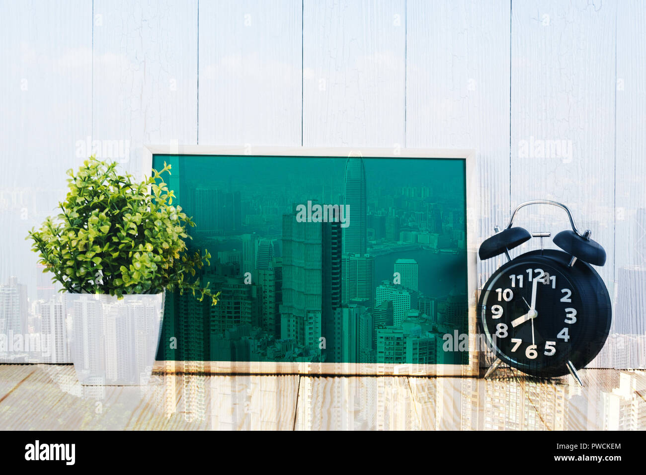 Double exposure coins stacks and alarm clock with green chalkboard ...