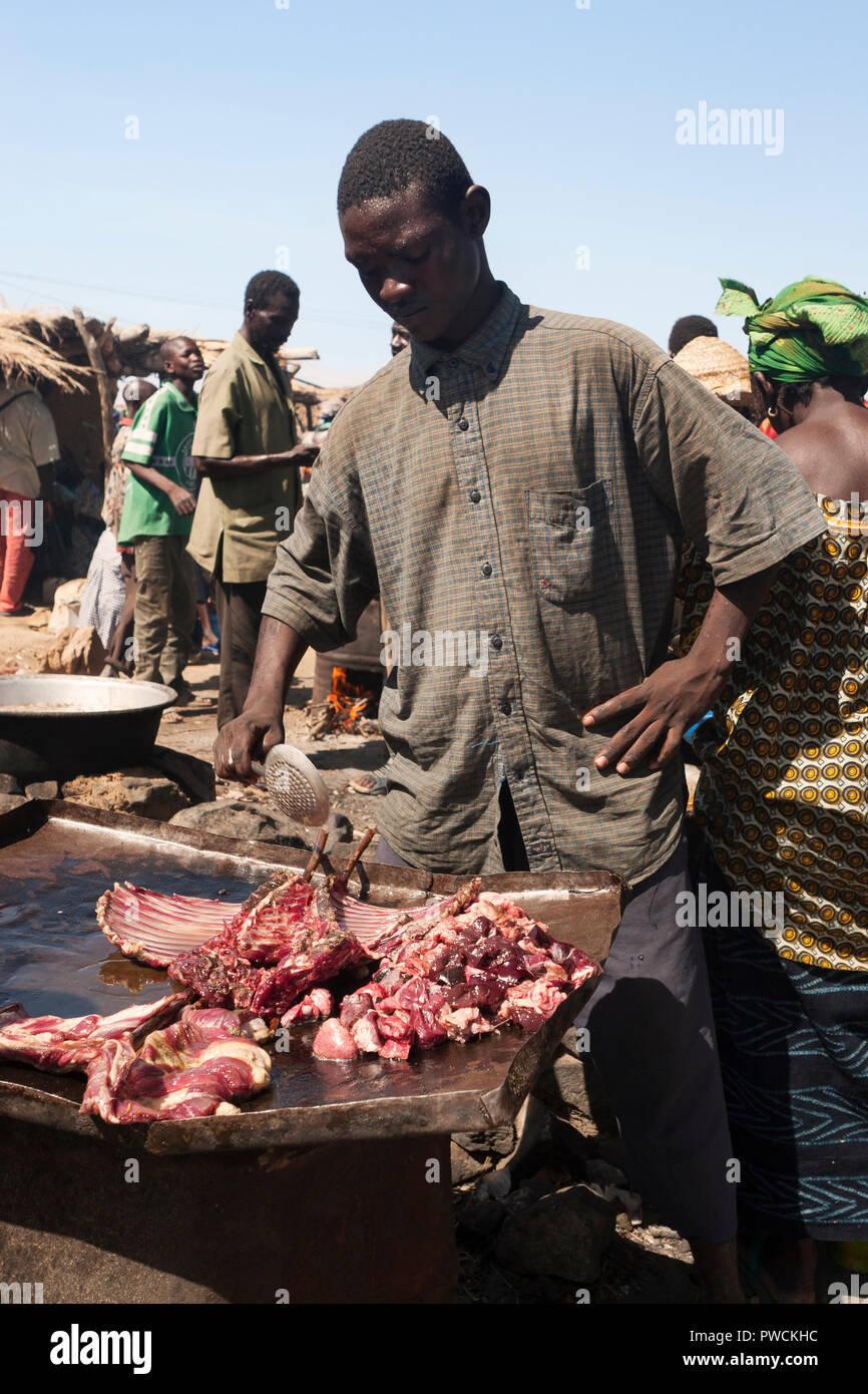 African man cooking meat hi-res stock photography and images - Alamy
